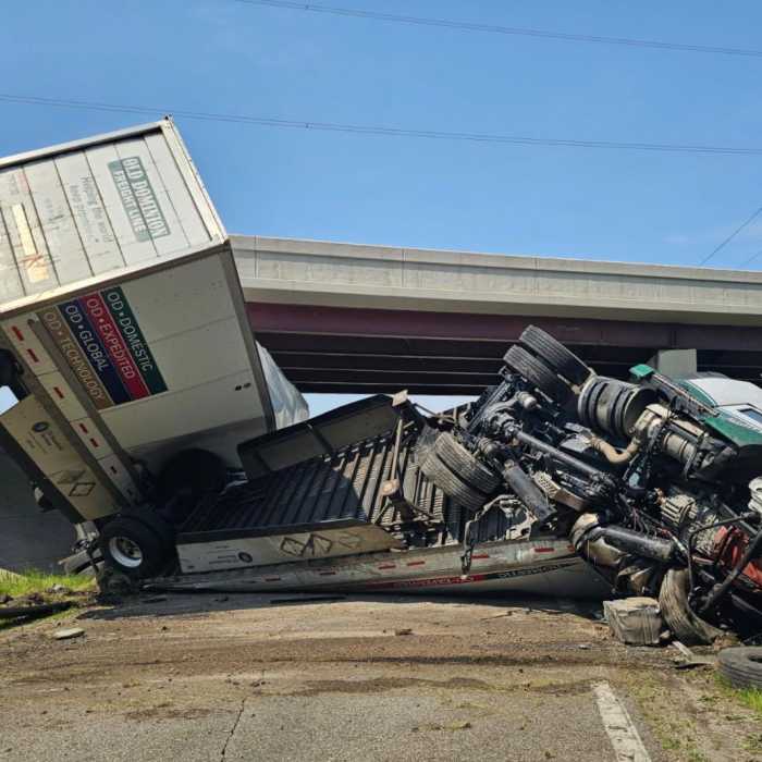 Two semis collide near I-94 bridge, sending one crashing onto underpass ...