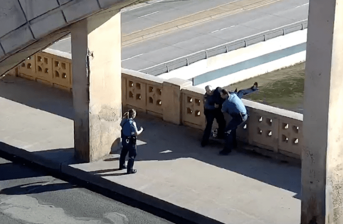 St. Paul police chief Todd Axtell helps pull woman to safety from ...